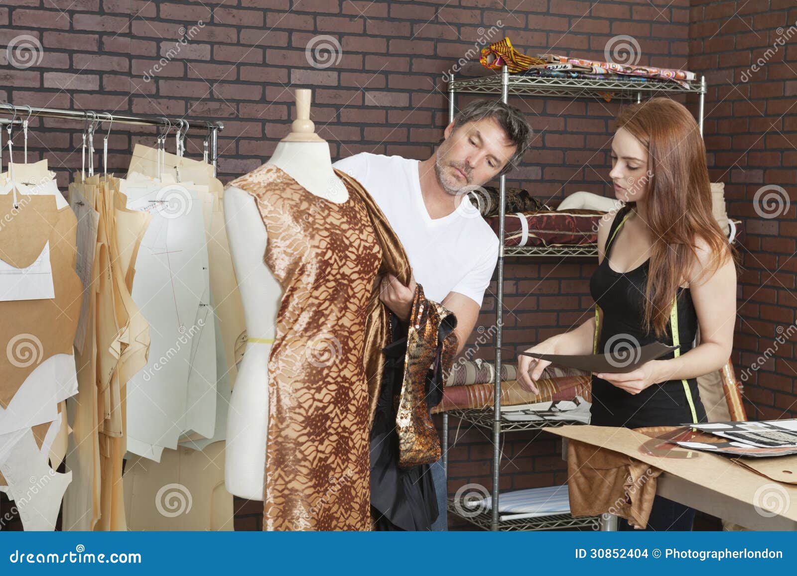 Fashion Designers Working Together on an Outfit in Design Studio Stock ...