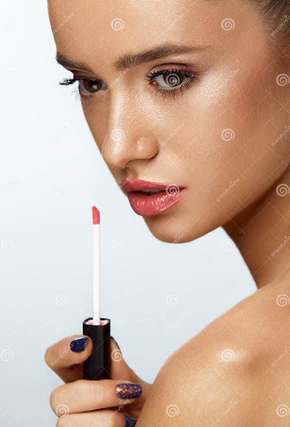 Fashion Female Model With Beauty Face Applying Lip Balm On Lips Stock