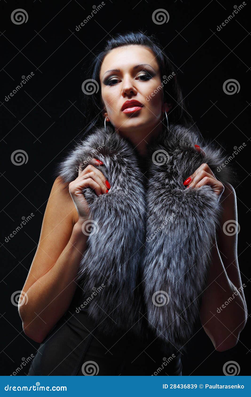 Fashion Model Posing in Studio Covering Her Neck in a Fur Stock Image ...