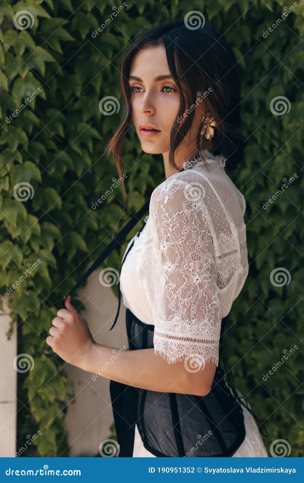 Beautiful Woman With Dark Hair In Elegant White Dress And Accessories