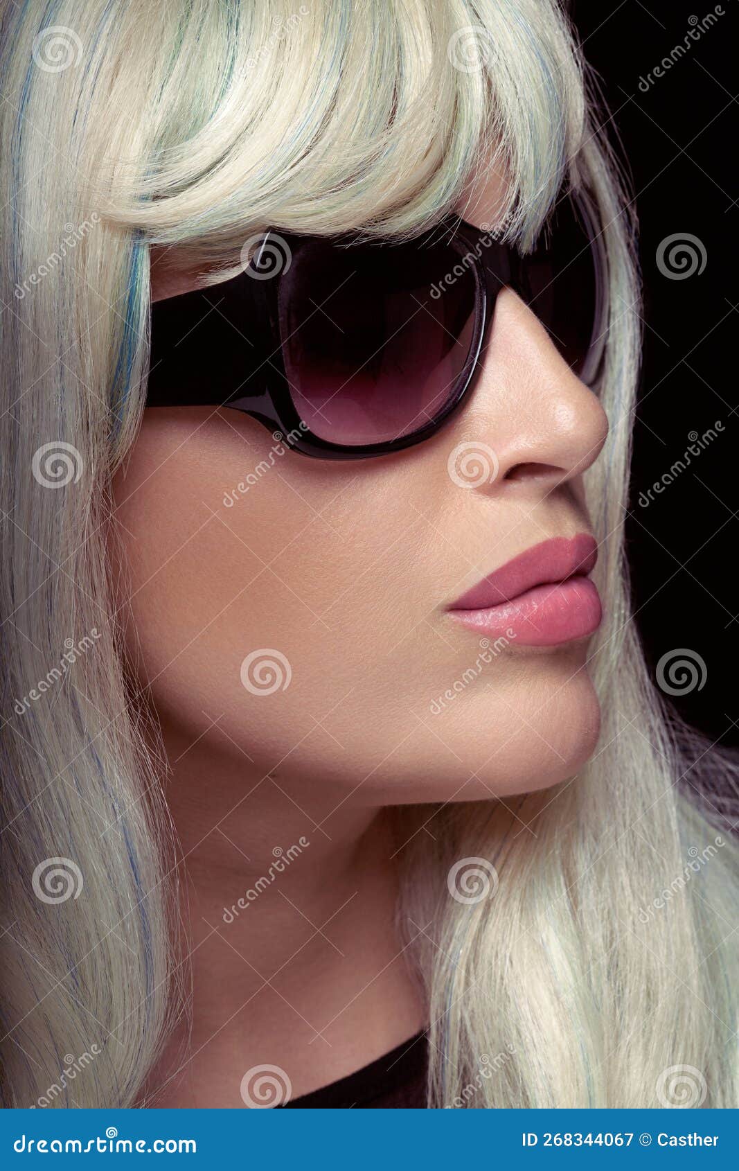 Fashion Portrait Of An Attractive Blonde Woman In Sunglasses On Black
