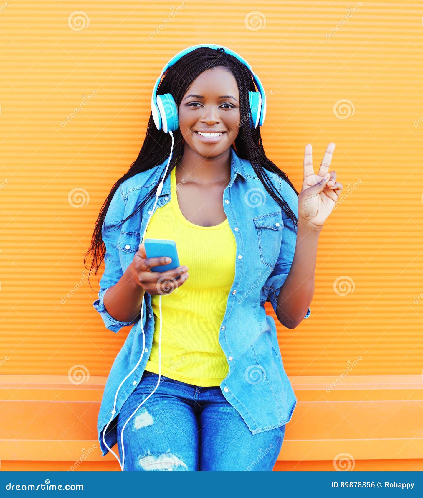 Fashion Pretty Smiling African Woman In A Headphones Listens To Music