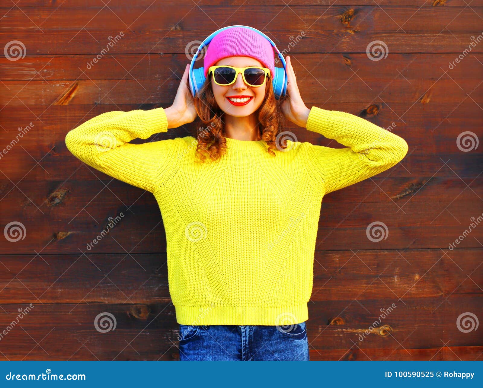 Fashion Smiling Woman Listens To Music In Headphones Stock Image