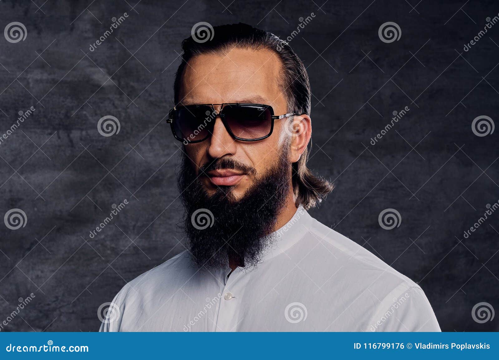 Bearded Male With Long Hair Dressed In A White Shirt And Sunglasses