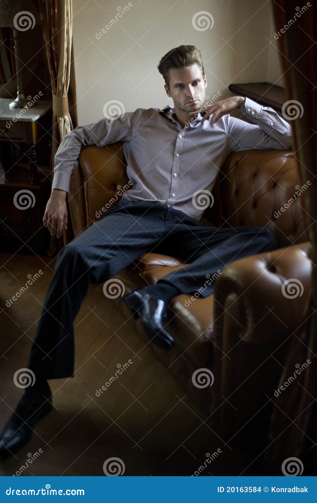 Fashionable man sitting stock photo. Image of flower - 20163584
