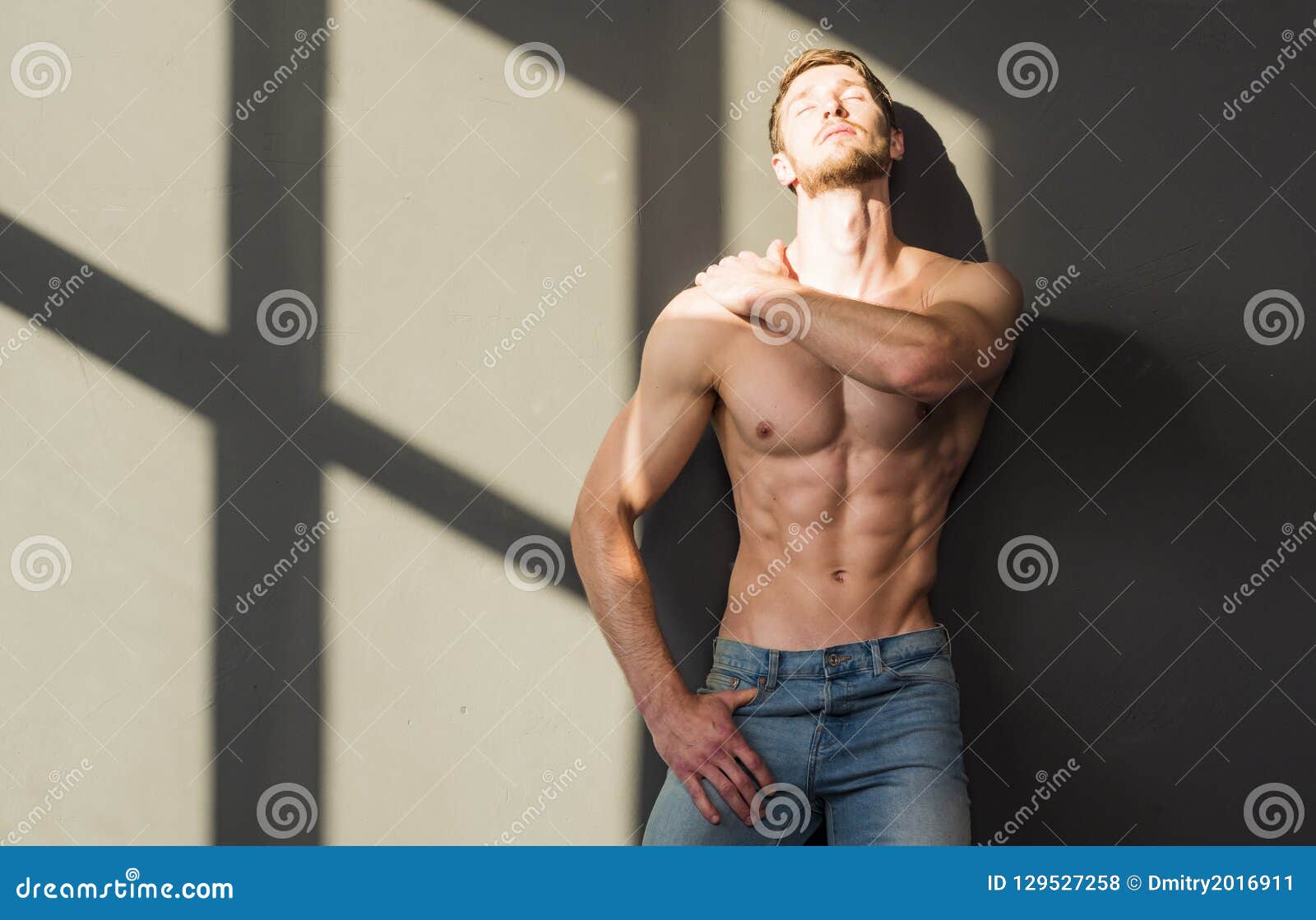 Fashionable Masculinity. Handsome Young Man Posing Next the Grey Wall ...