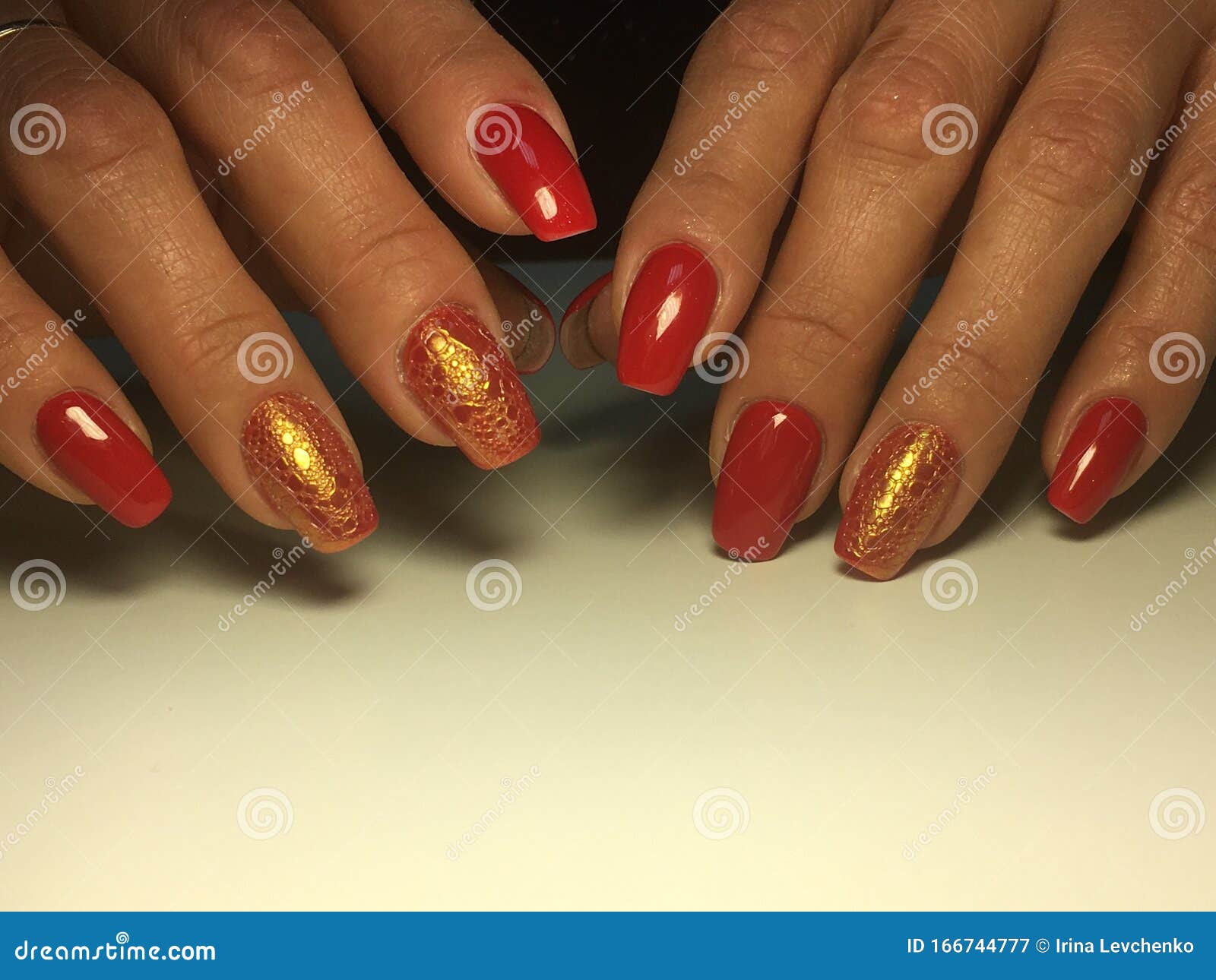 Fashionable Red Manicure with Golden Ruby Design on Long Nails Stock ...