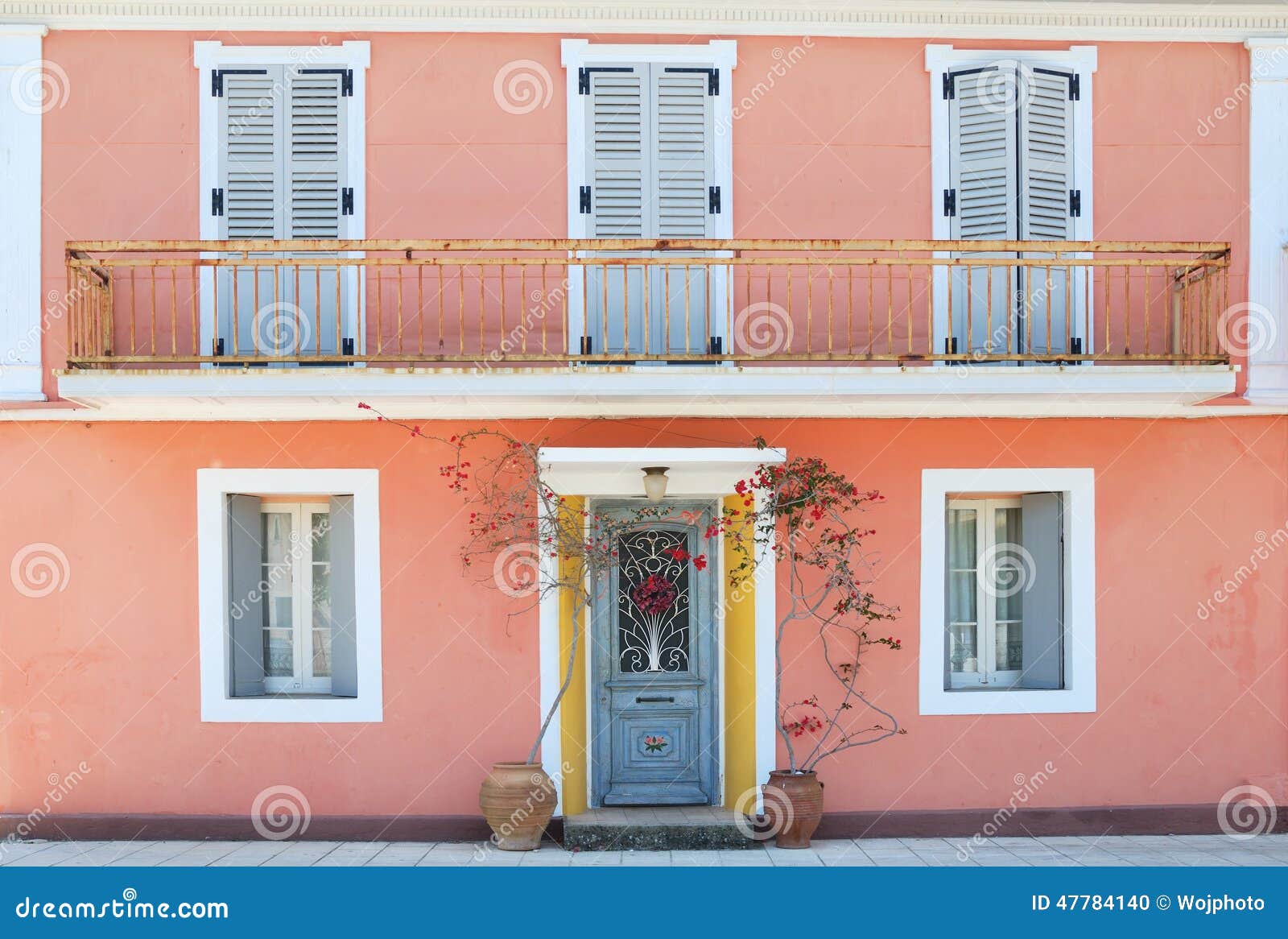 Fassade Eines Reizenden Griechischen Hauses Mit Blumen Und Balkon ...
