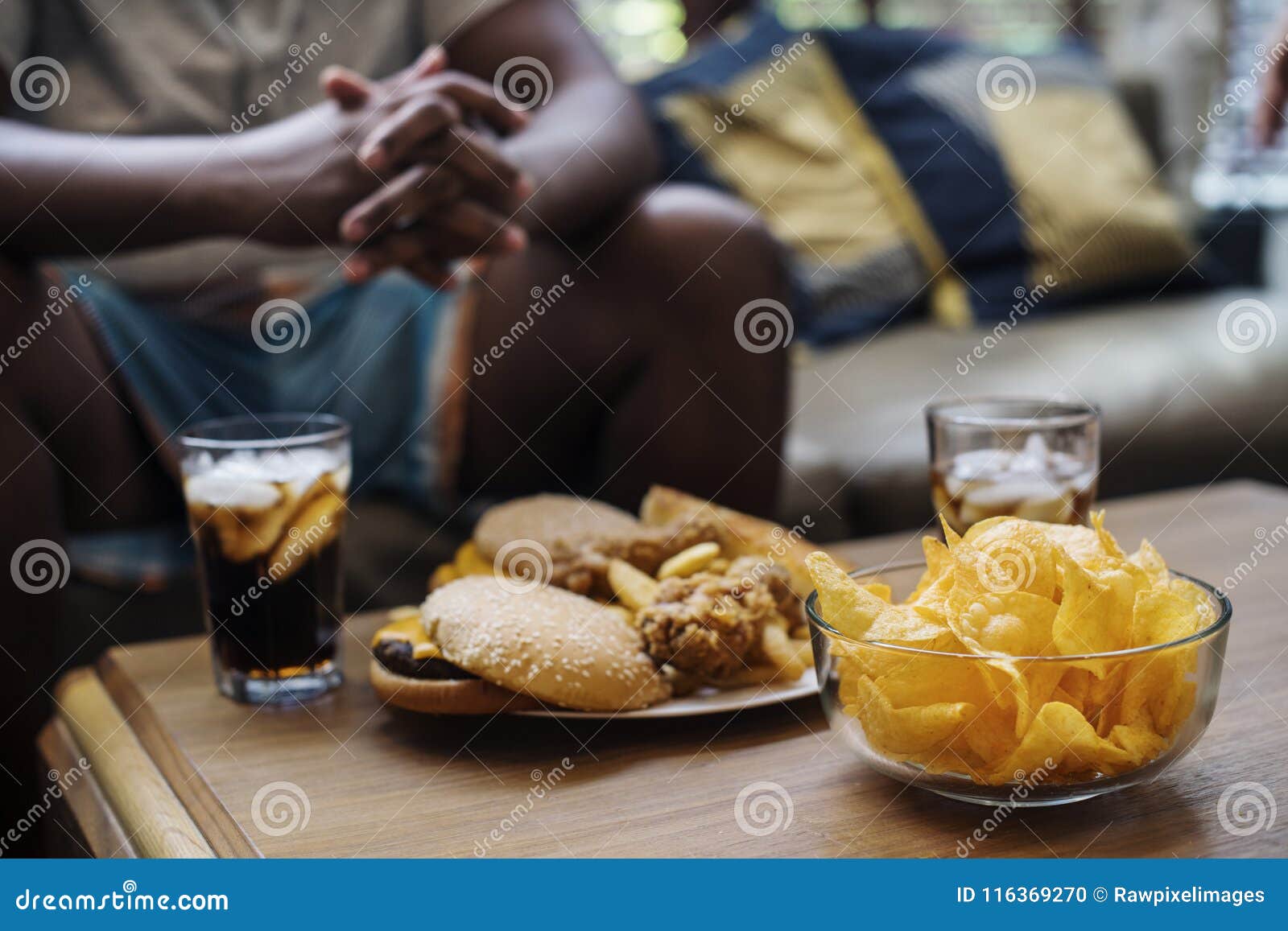 Fast food on a sofa table stock photo. Image of dinner - 116369270