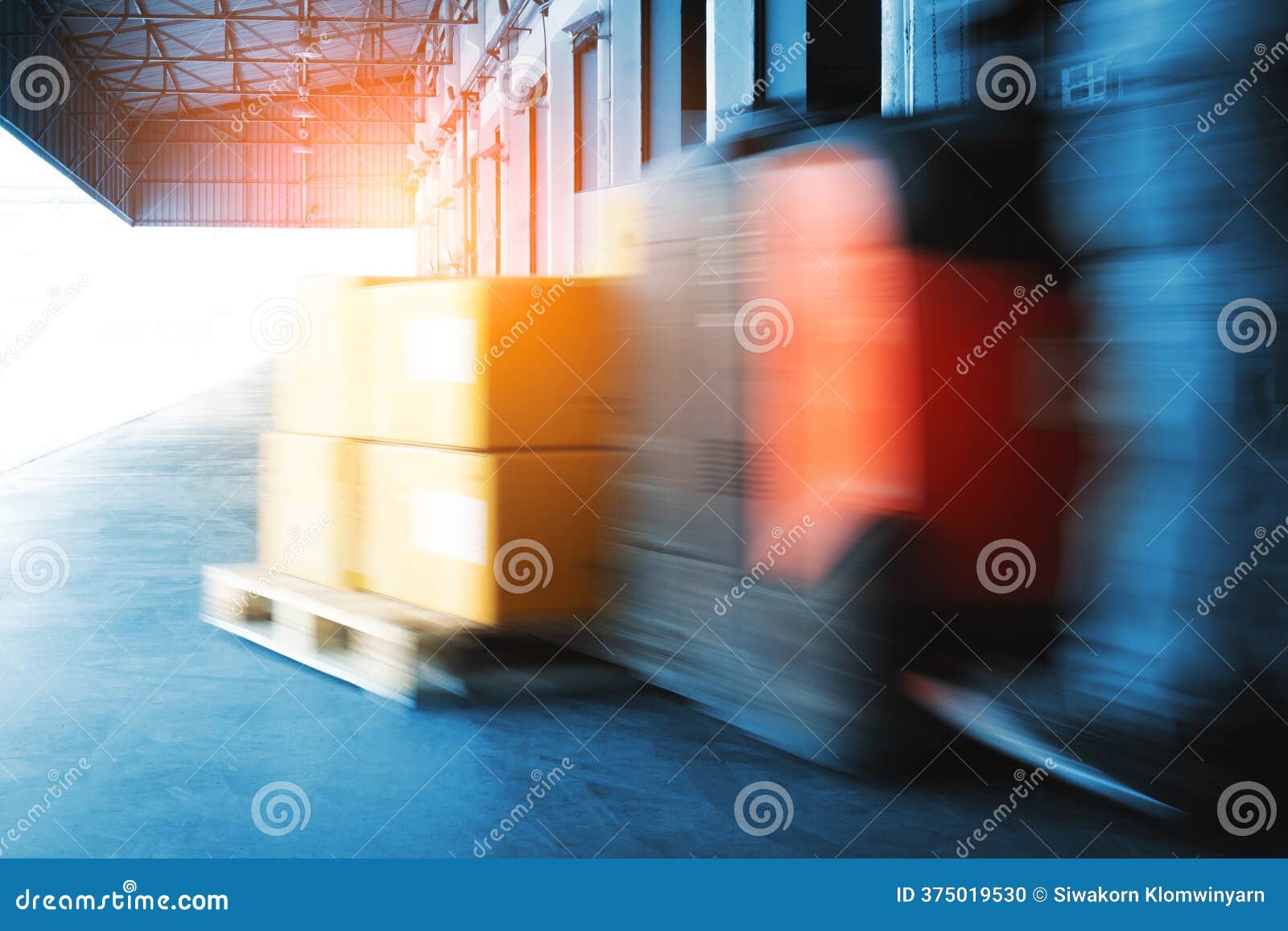 Forklift Loading Wood Planks Into Storage At A Warehouse During Sunset ...