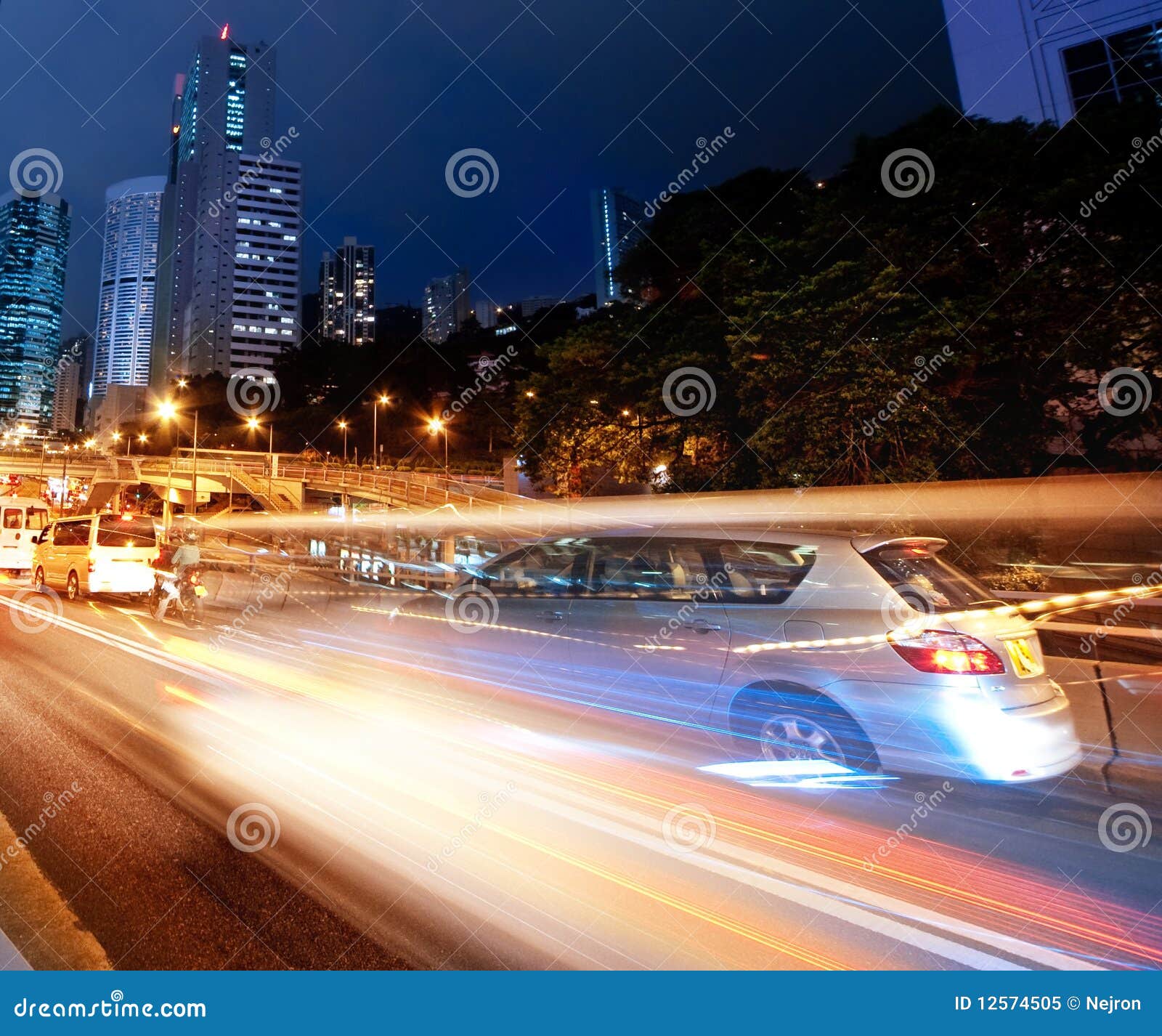 Fast moving cars at night stock image. Image of building - 12574505