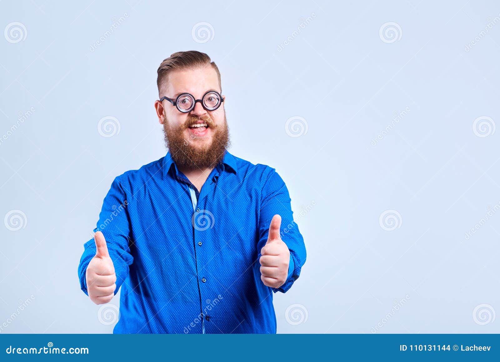 A Fat Bearded Man With Glasses On A Gray Background With A Posi Stock