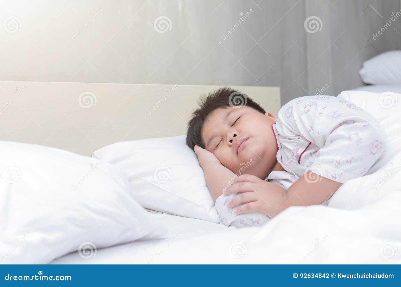 Fat boy sleep on bed stock photo. Image of innocence - 92634842