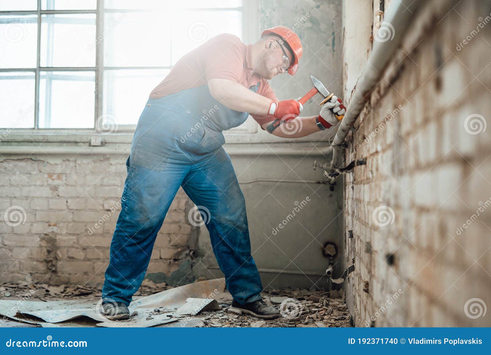 Fat Builder on a Construction Site Working on a Brick Wall with a ...