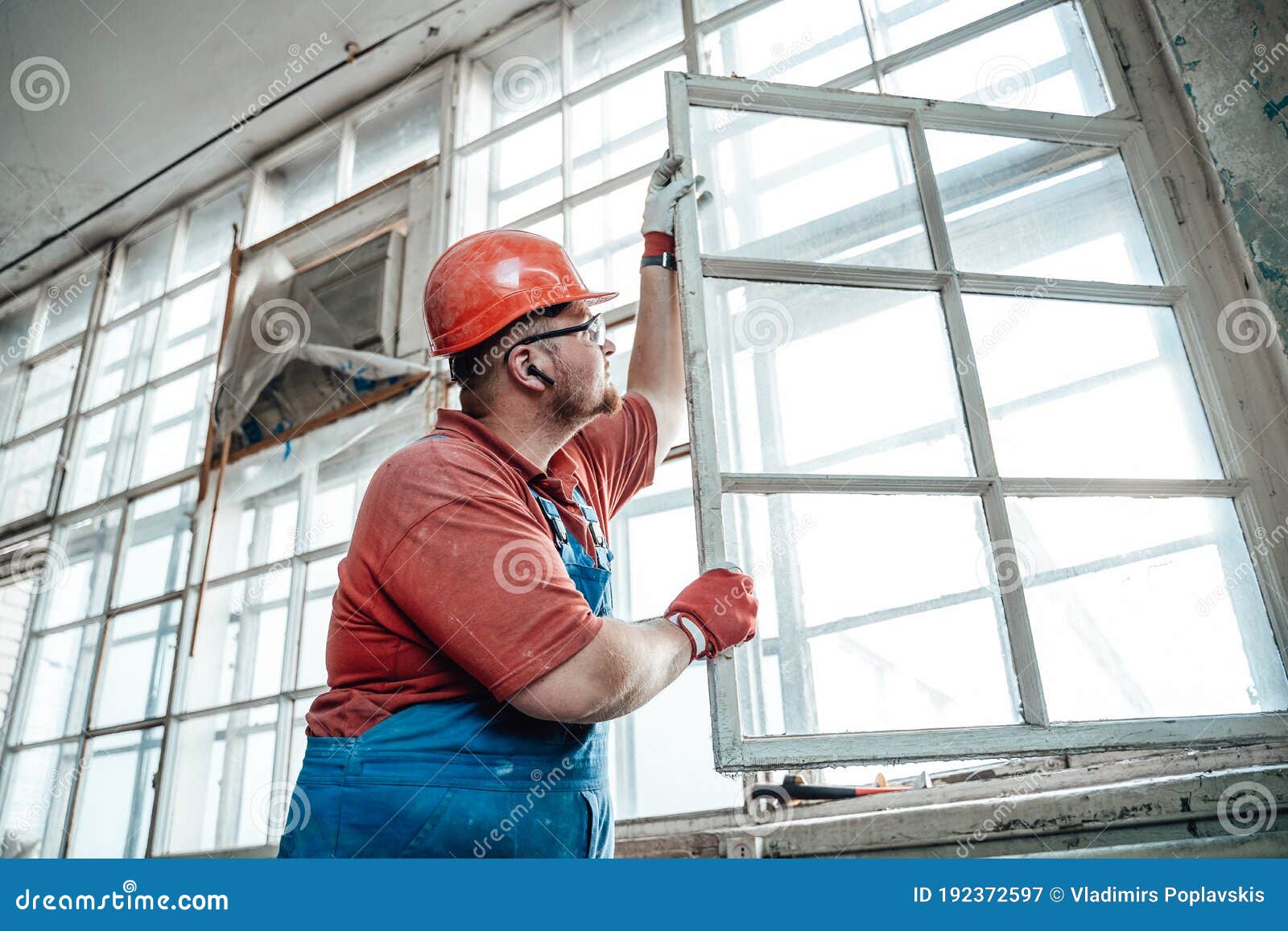 Fat Builder Working with a Window at a Big Construction Site Stock ...