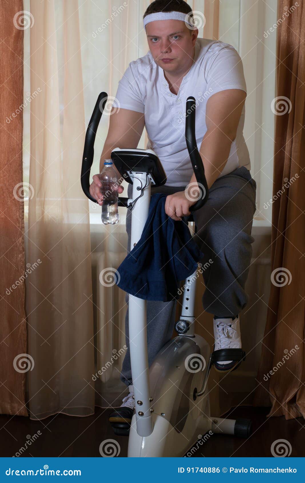 Fat Guy Exercising on Stationary Training Bicycle Stock Photo - Image ...