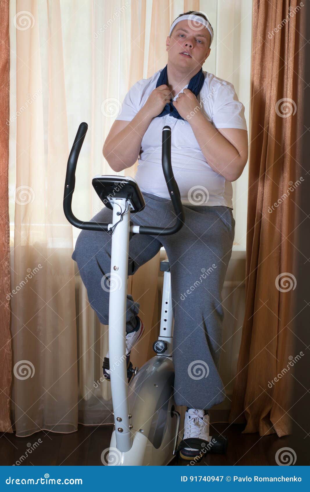 Fat Guy Exercising on Stationary Training Bicycle Stock Image - Image ...