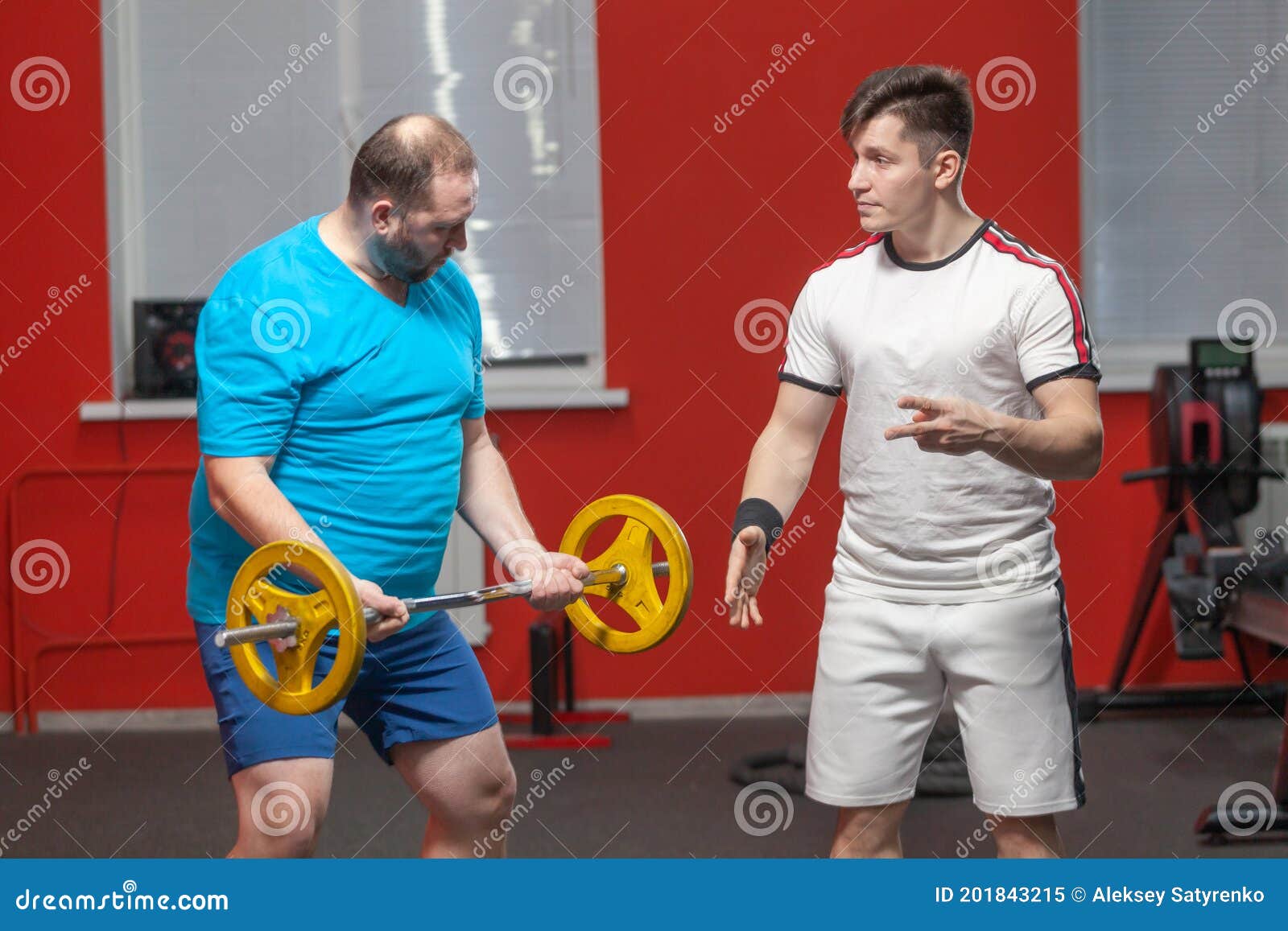 A Fat Man in the Gym Performs Barbell Lifting Exercises at the Limit of ...