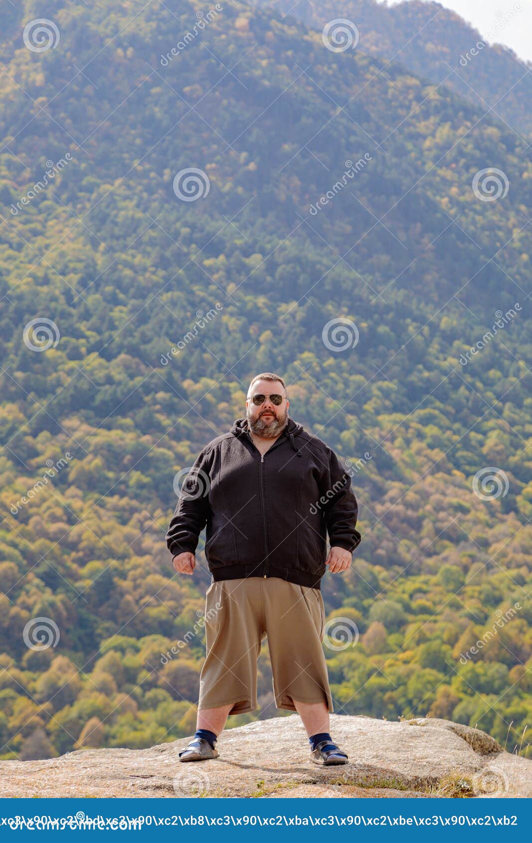 The Fat Man Stands on the Top of the Mountain. Stock Photo - Image of ...