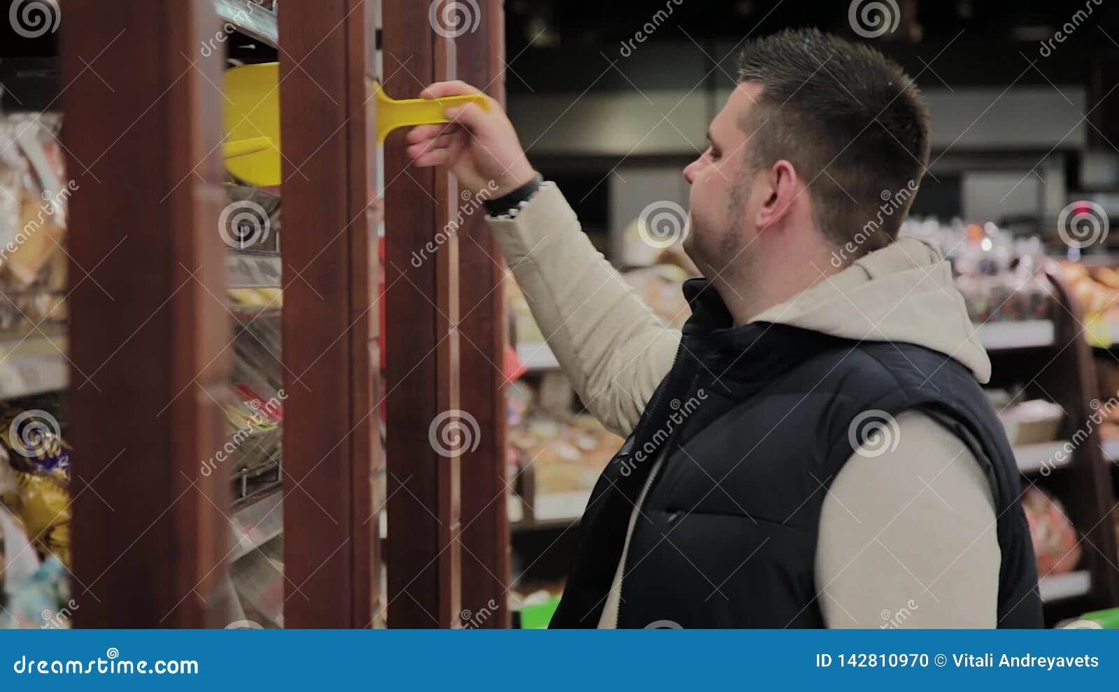 Fat Man in the Supermarket Chooses Sweets for Himself. Stock Footage ...
