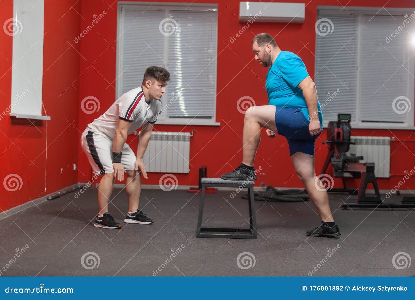 Fat Man is Diligently Doing Step-up Exercise Under Control of a ...