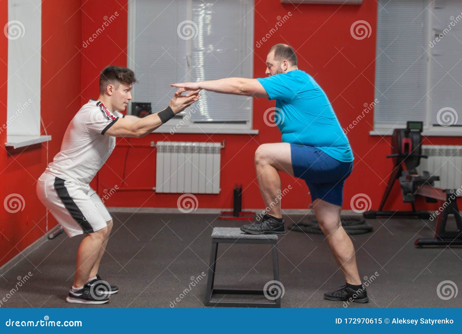 Fat Man is Diligently Doing Step-up Exercise Under Control of a ...