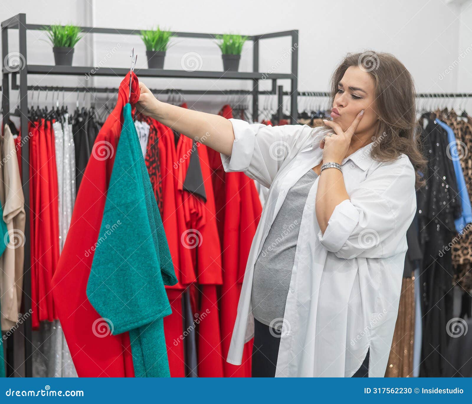 A Fat Woman Chooses Clothes in a Plus Size Store. Stock Photo - Image ...