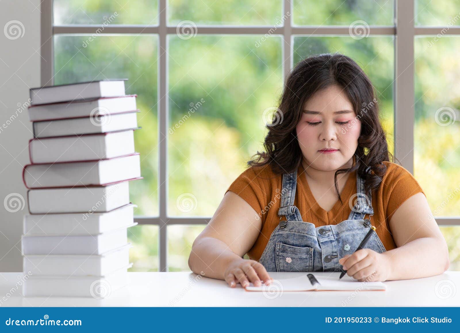 Fat Woman Student with Concentration Sitting and Holding Pen Writing on ...