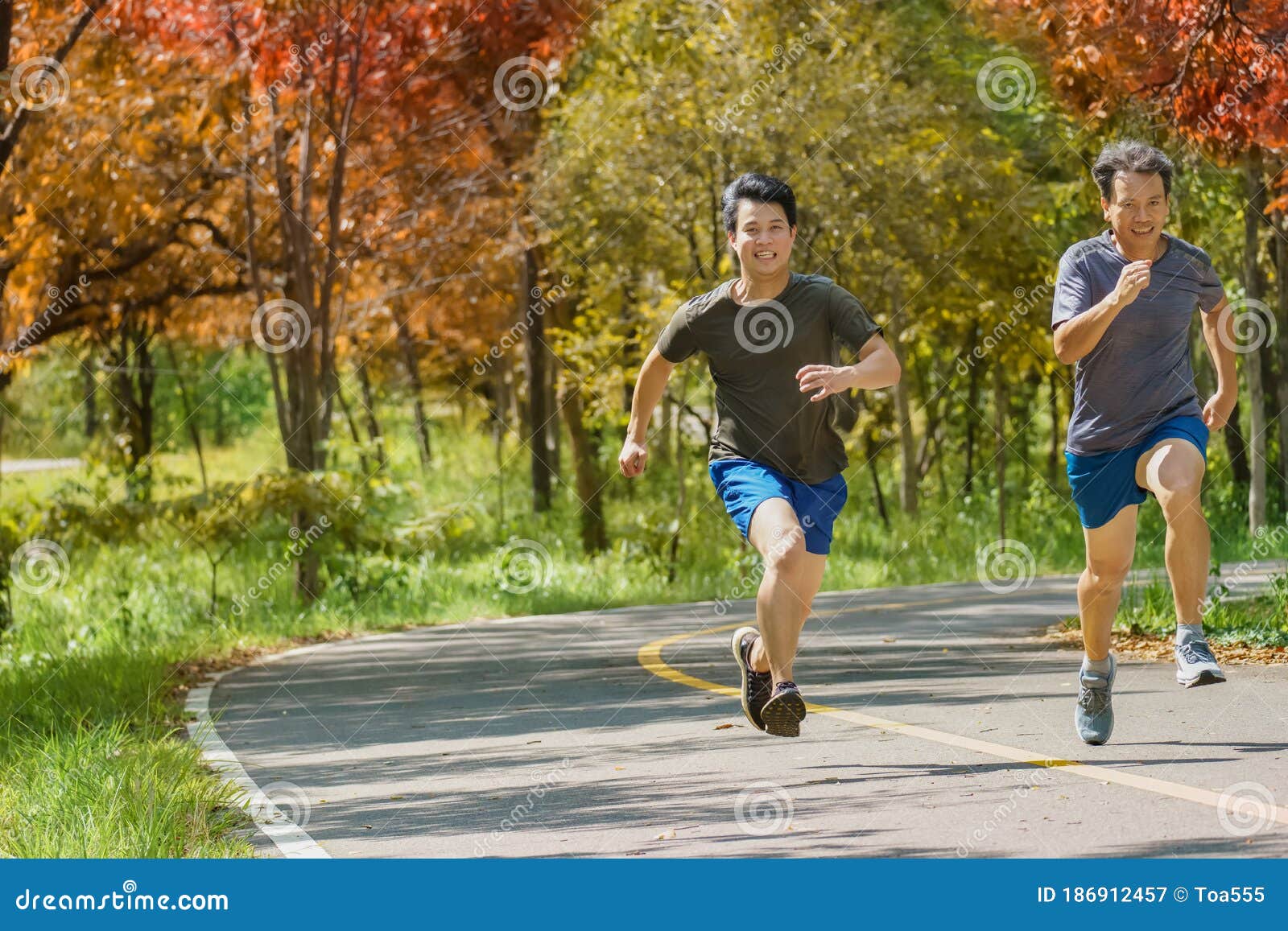 Father and Adult Son Running Together in Park Stock Image - Image of ...