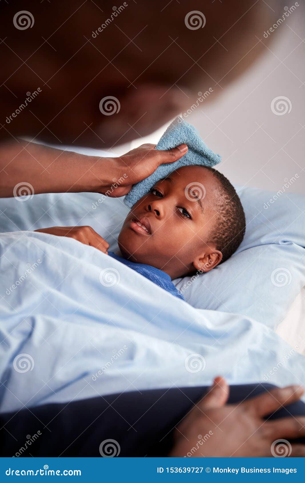 Father Caring for Sick Son Ill in Bed with Temperature Stock Image ...