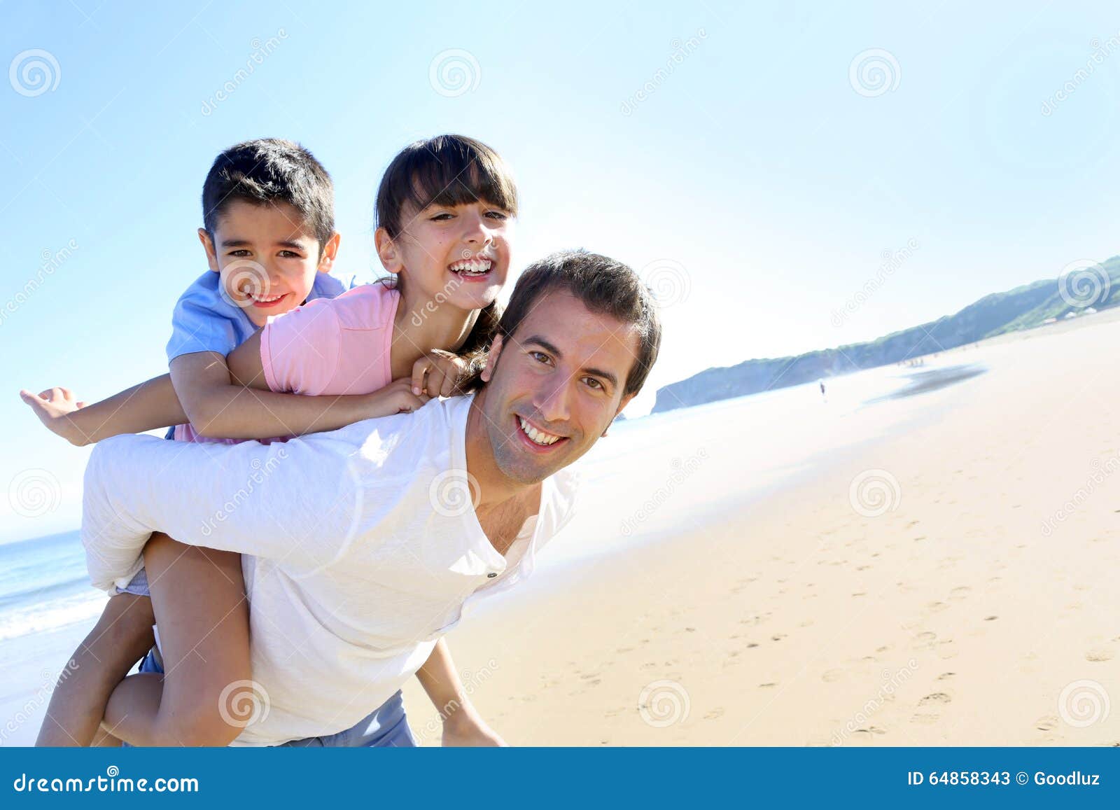 Father Carrying Two Children on His Back on the Beach Stock Image ...