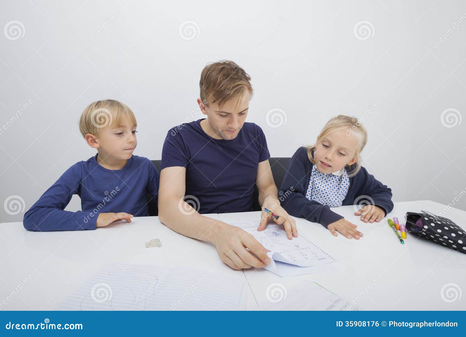 Father Checking Children S Homework at Table Stock Photo - Image of ...