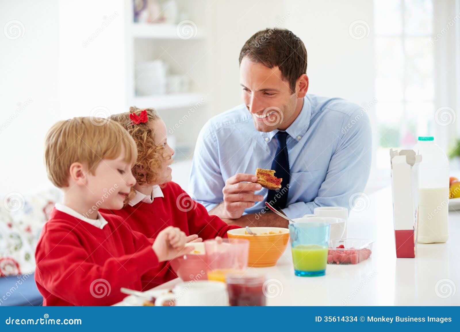 Father and Children Having Breakfast in Kitchen Together Stock Photo ...