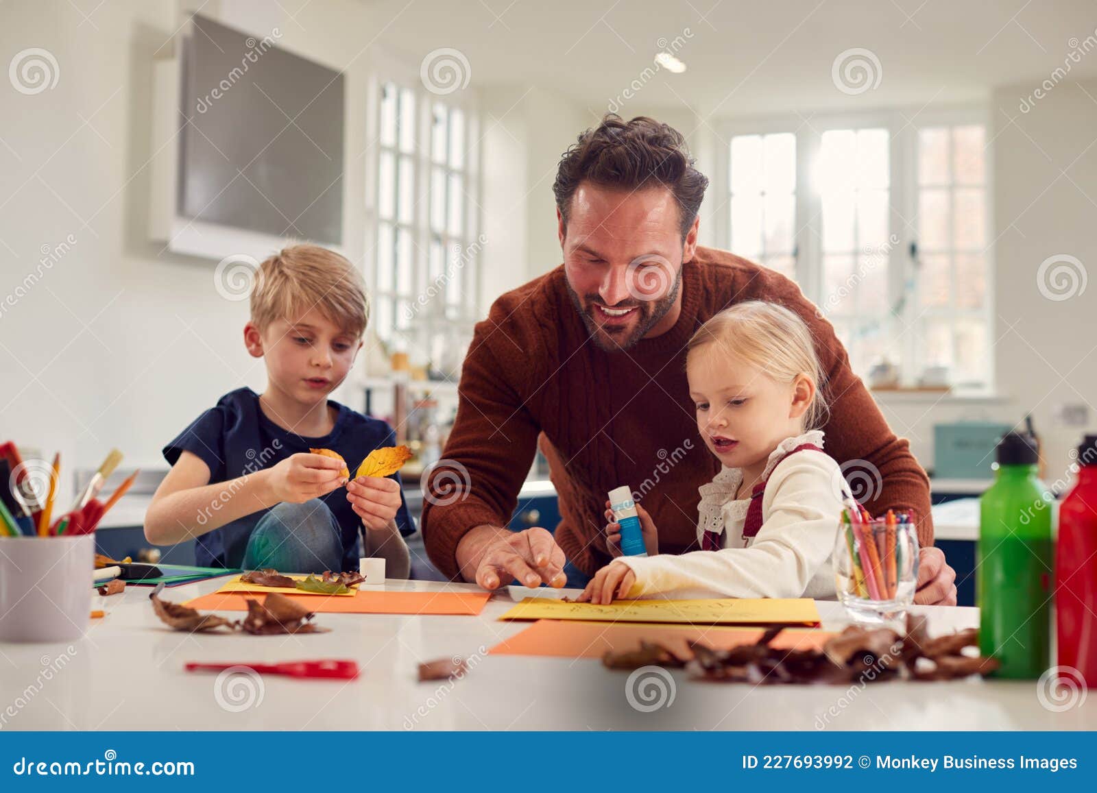 Father with Children at Home Doing Craft and Making Picture from Leaves ...