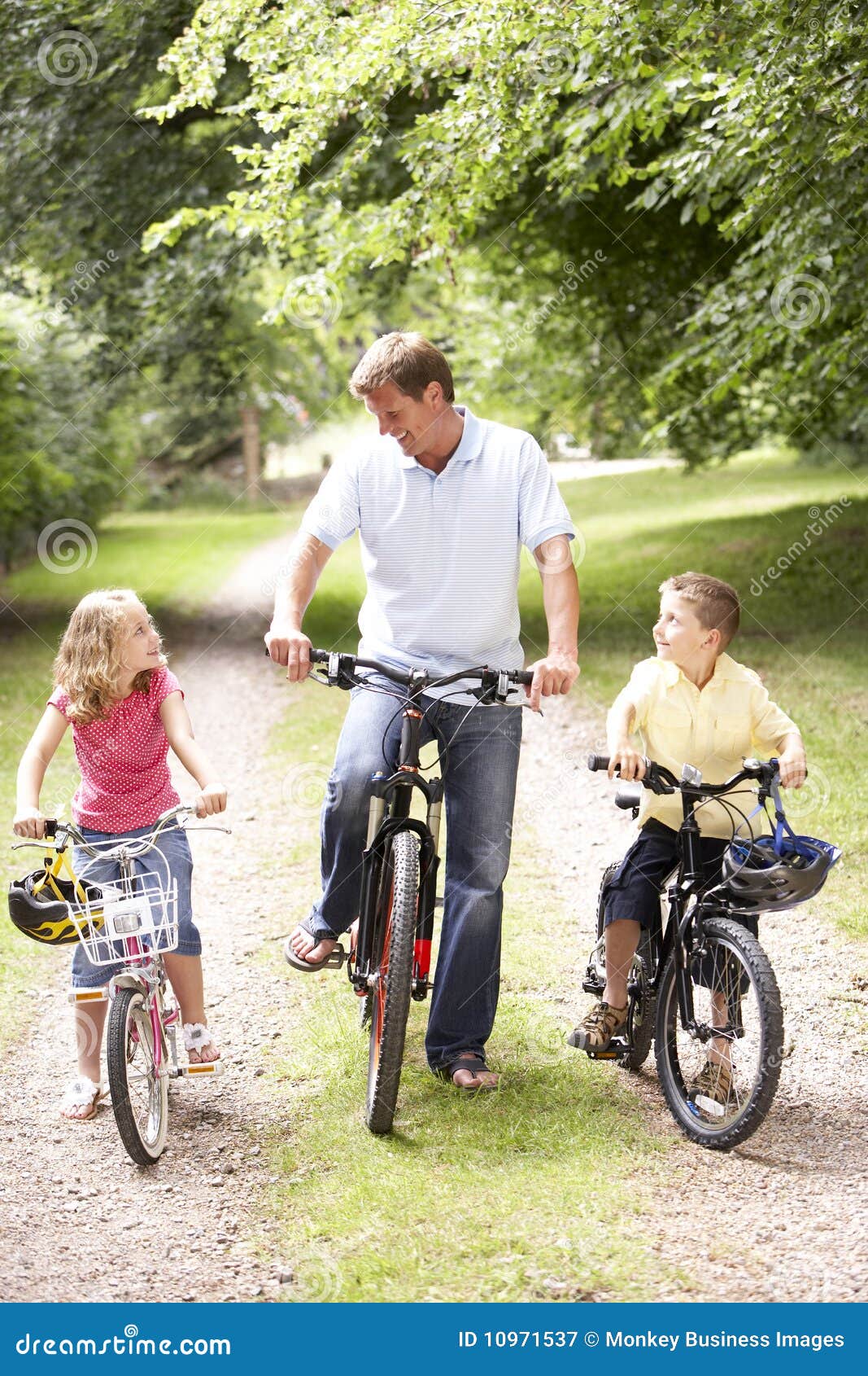 Father and Children Riding Bikes in Countryside Stock Image - Image of ...