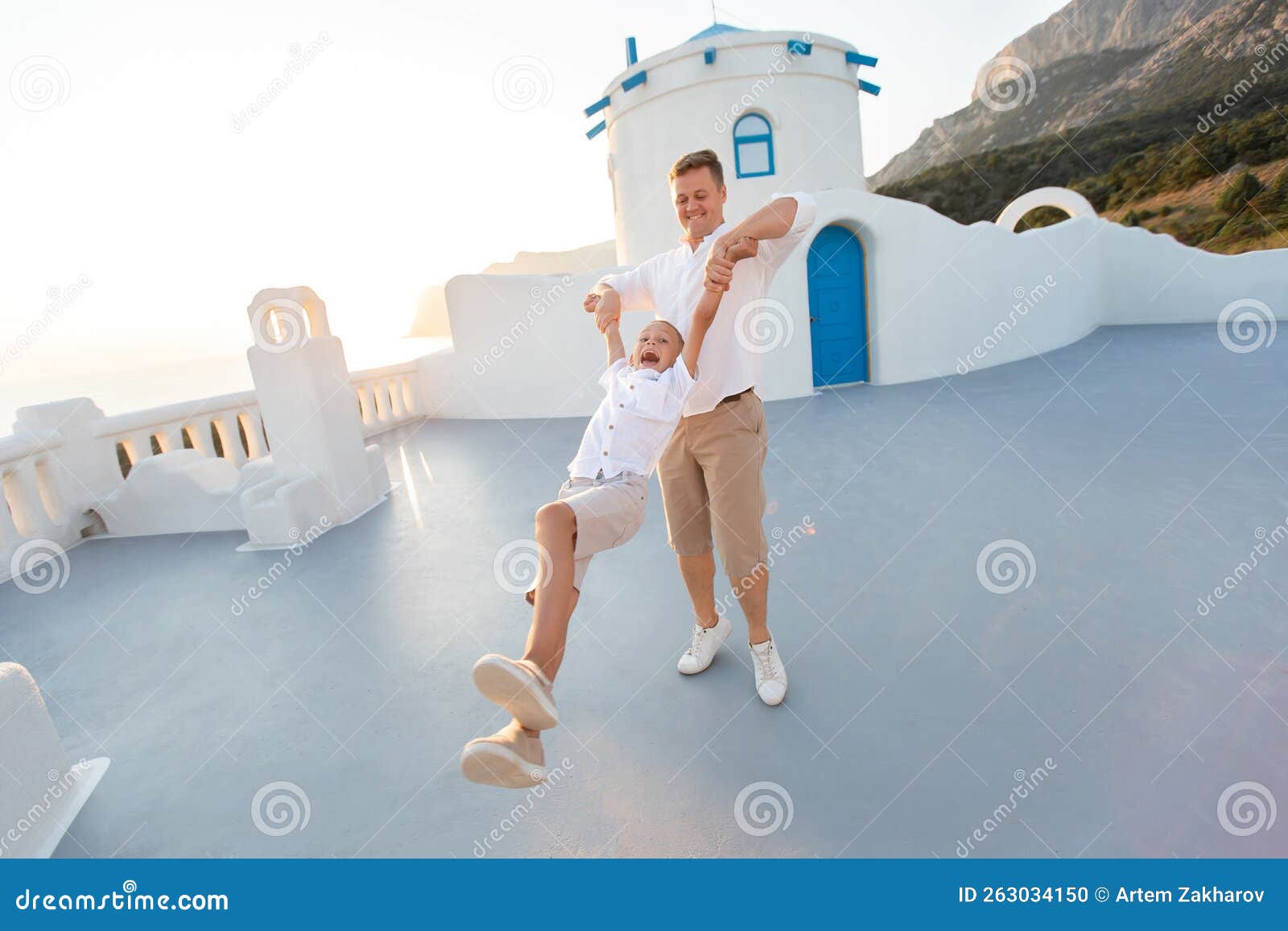 Father Circles His Son at Sunset. on the Island of Santorini, Greece ... Father Circles His Son at Sunset. on the Island of Santorini, Greece ...