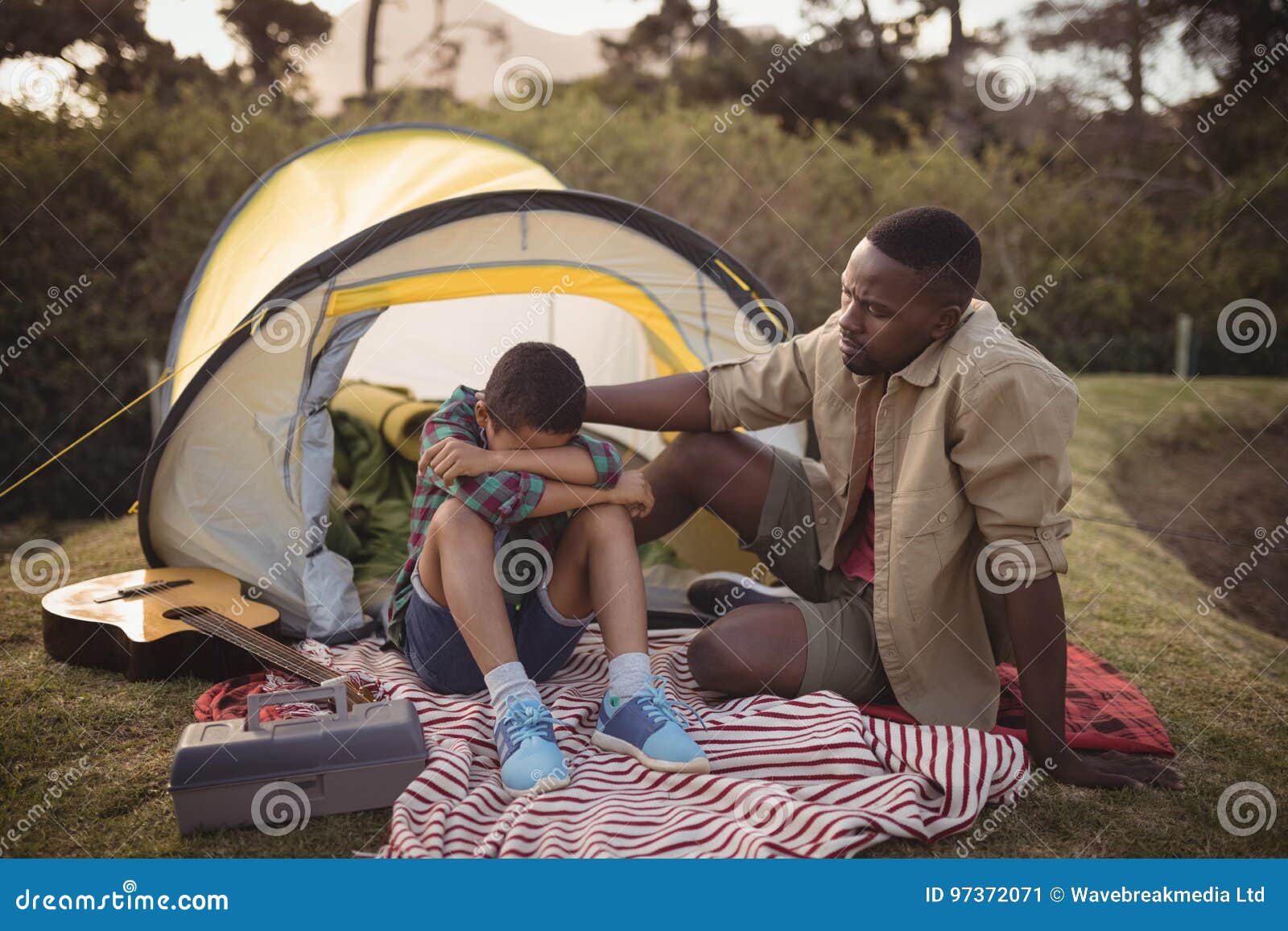 Father Comforting His Son in Park Stock Image - Image of male, father ...