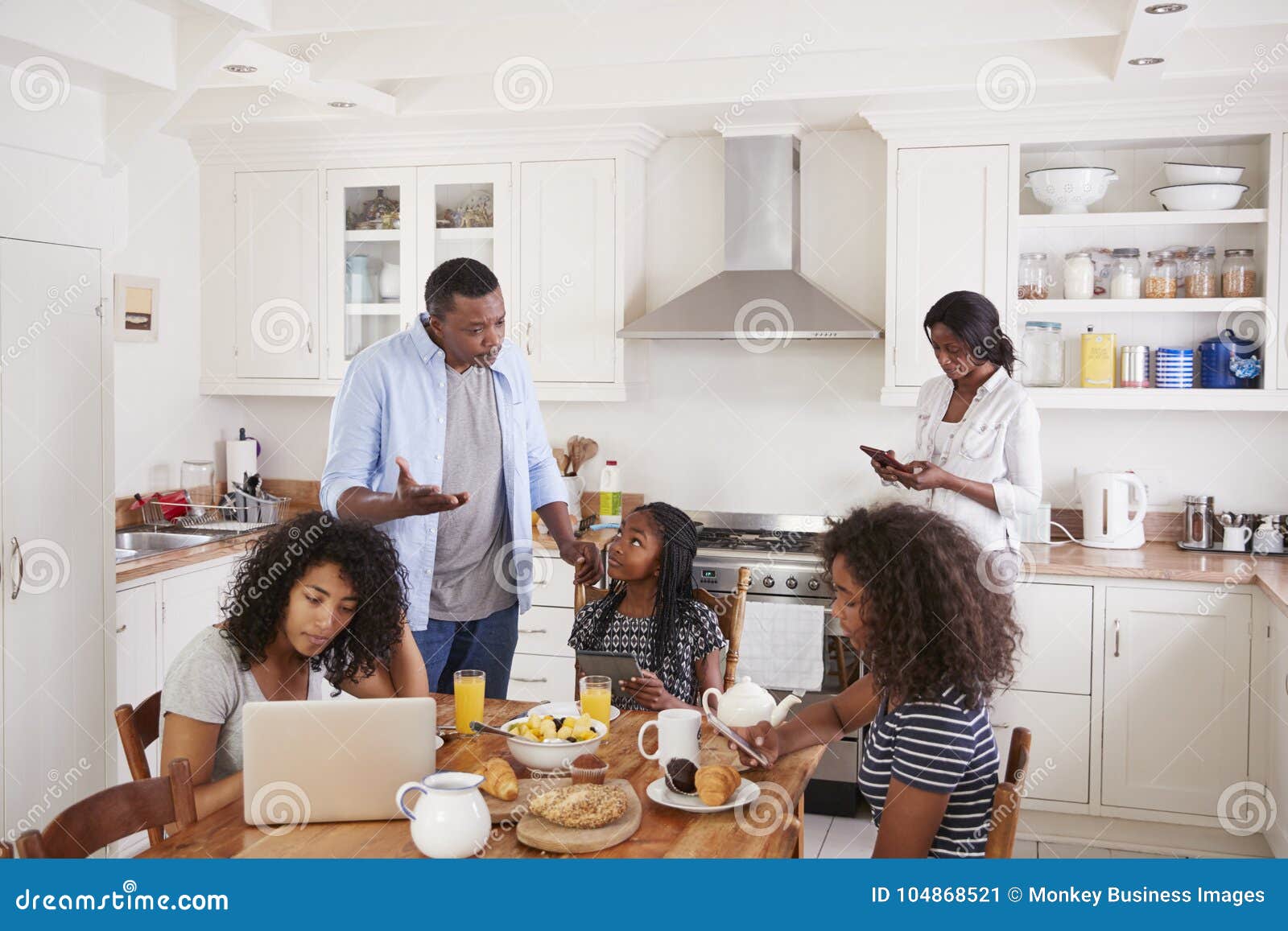 Father Concerned with Excessive Use of Technology by Family Stock Image ...