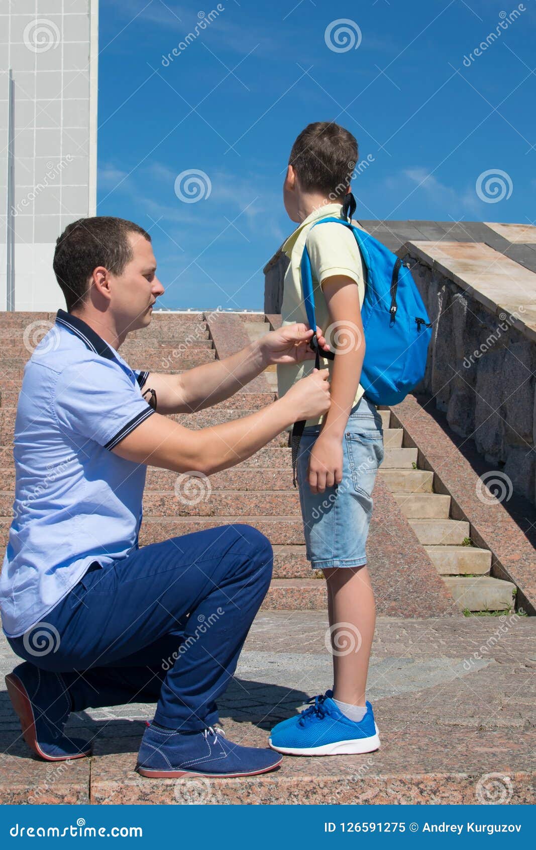 Father Corrects His Son, a Blue School Backpack Strap Stock Image ...