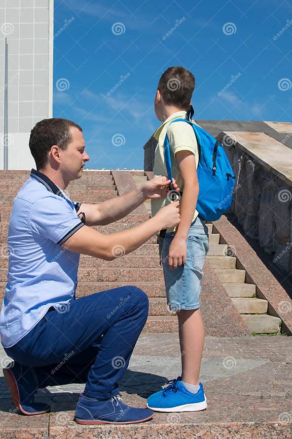 Father Corrects His Son, a Blue School Backpack Strap Stock Image ...
