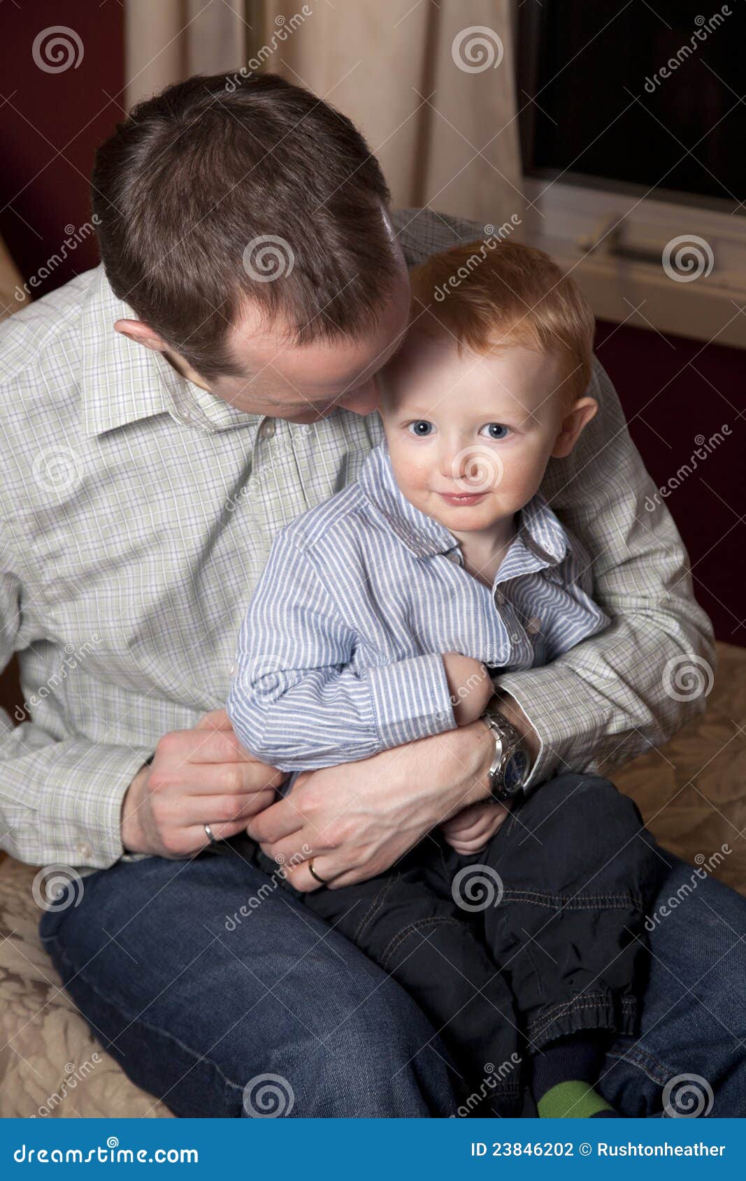 Father cuddling son stock photo. Image of sitting, inside - 23846202