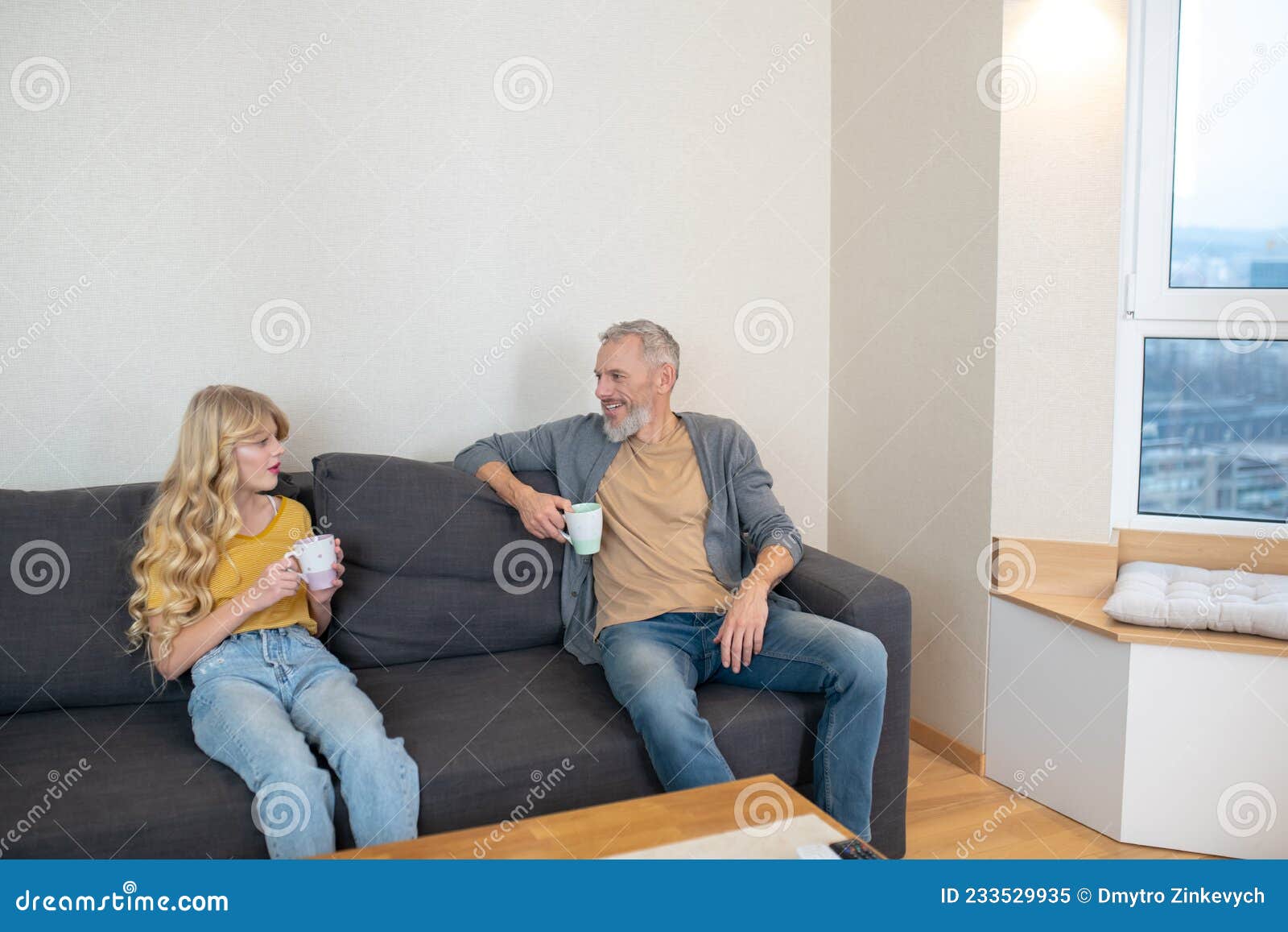 Father And Daughter Sitting On The Sofa At Home Stock Image Image Of