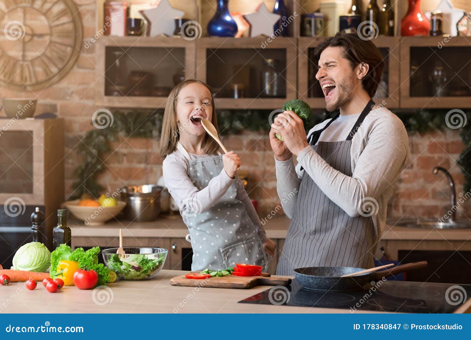 Father and Daughter Having Fun while Preparing Lunch in Kitchen ...