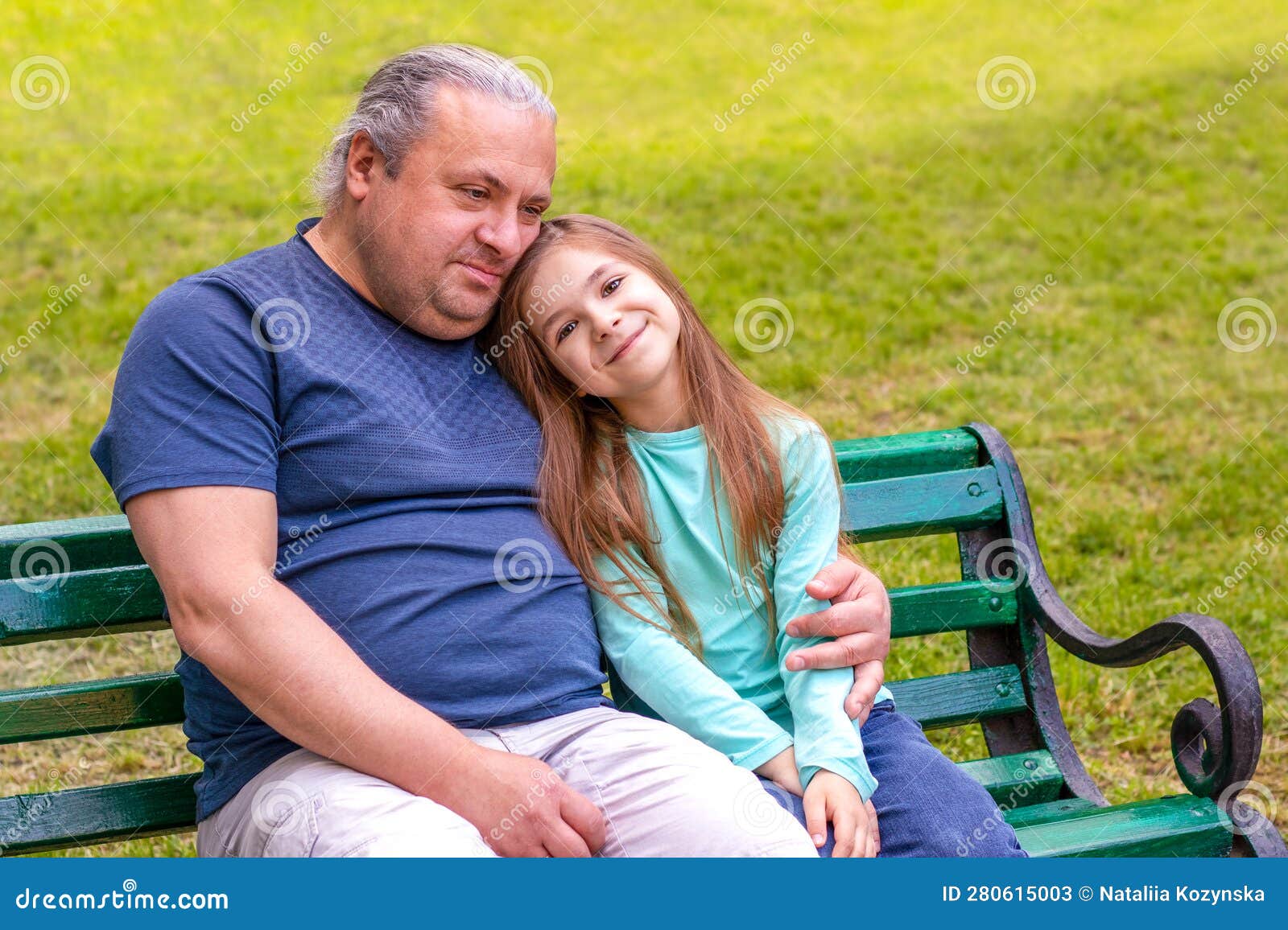 Father And Daughter Hugging While Sitting On A Park Bench Father S Day