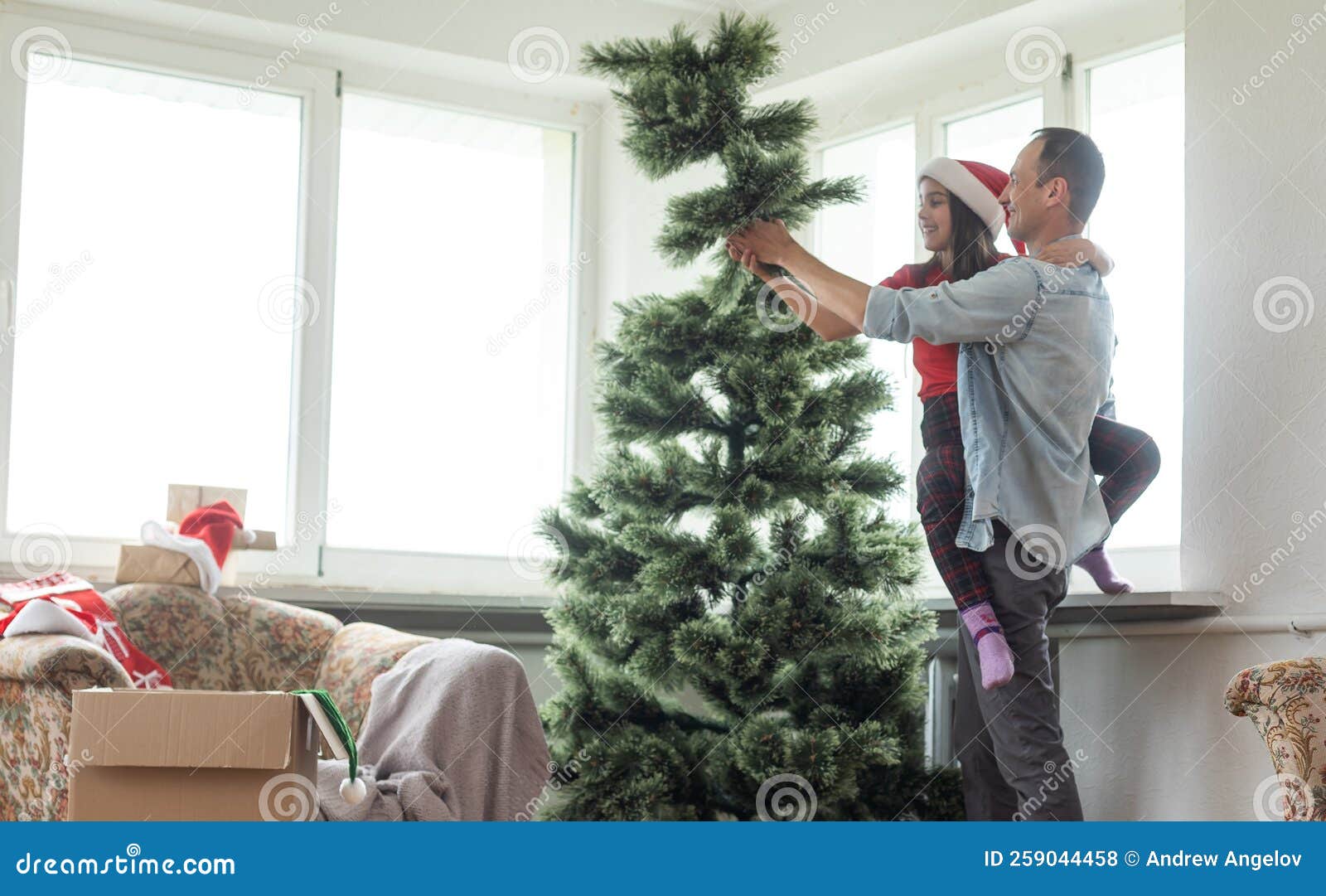 Father and Daughter Install an Artificial Christmas Tree Stock Photo ...