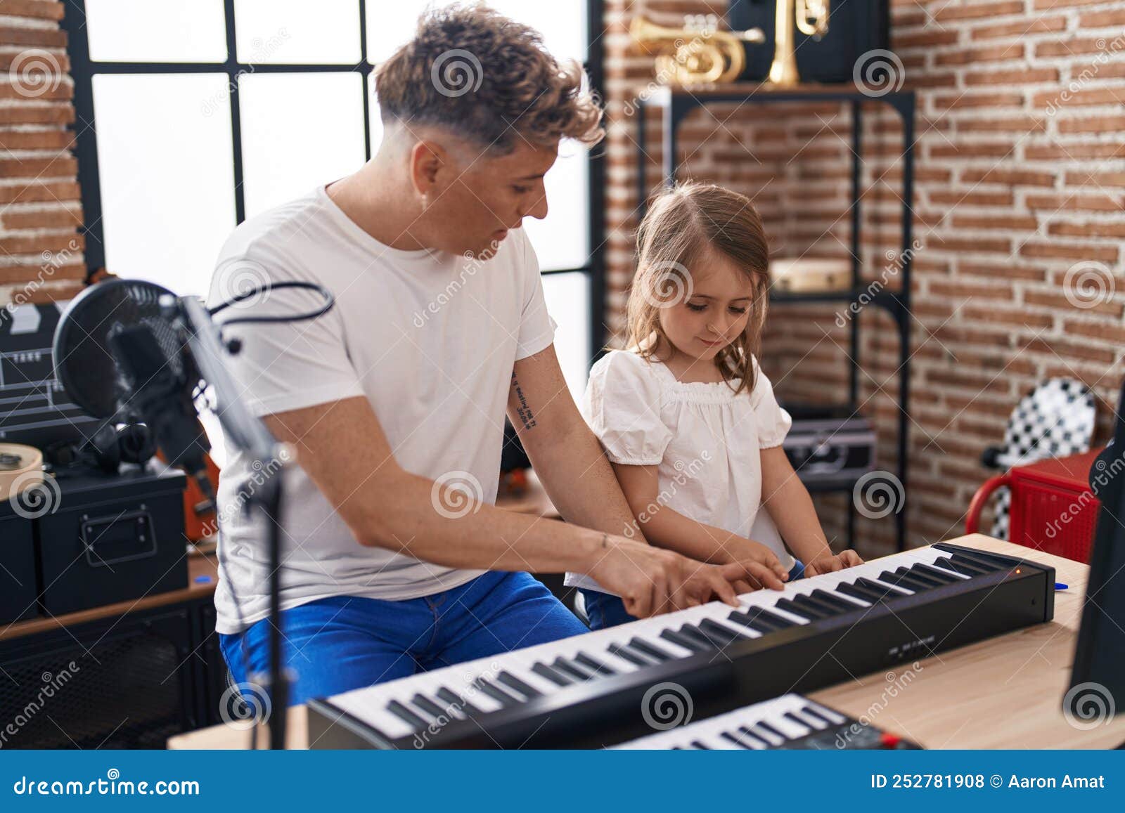 Father and Daughter Playing Piano Keyboard at Music Studio Stock Photo ...