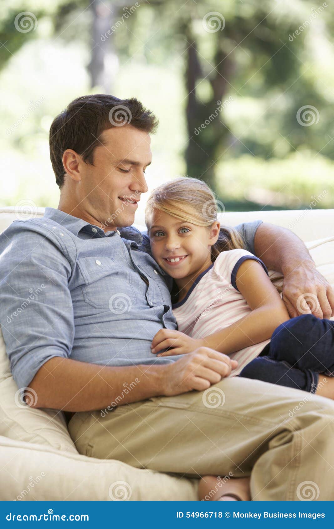 Father and Daughter Sitting on Sofa at Home Stock Photo - Image of ...