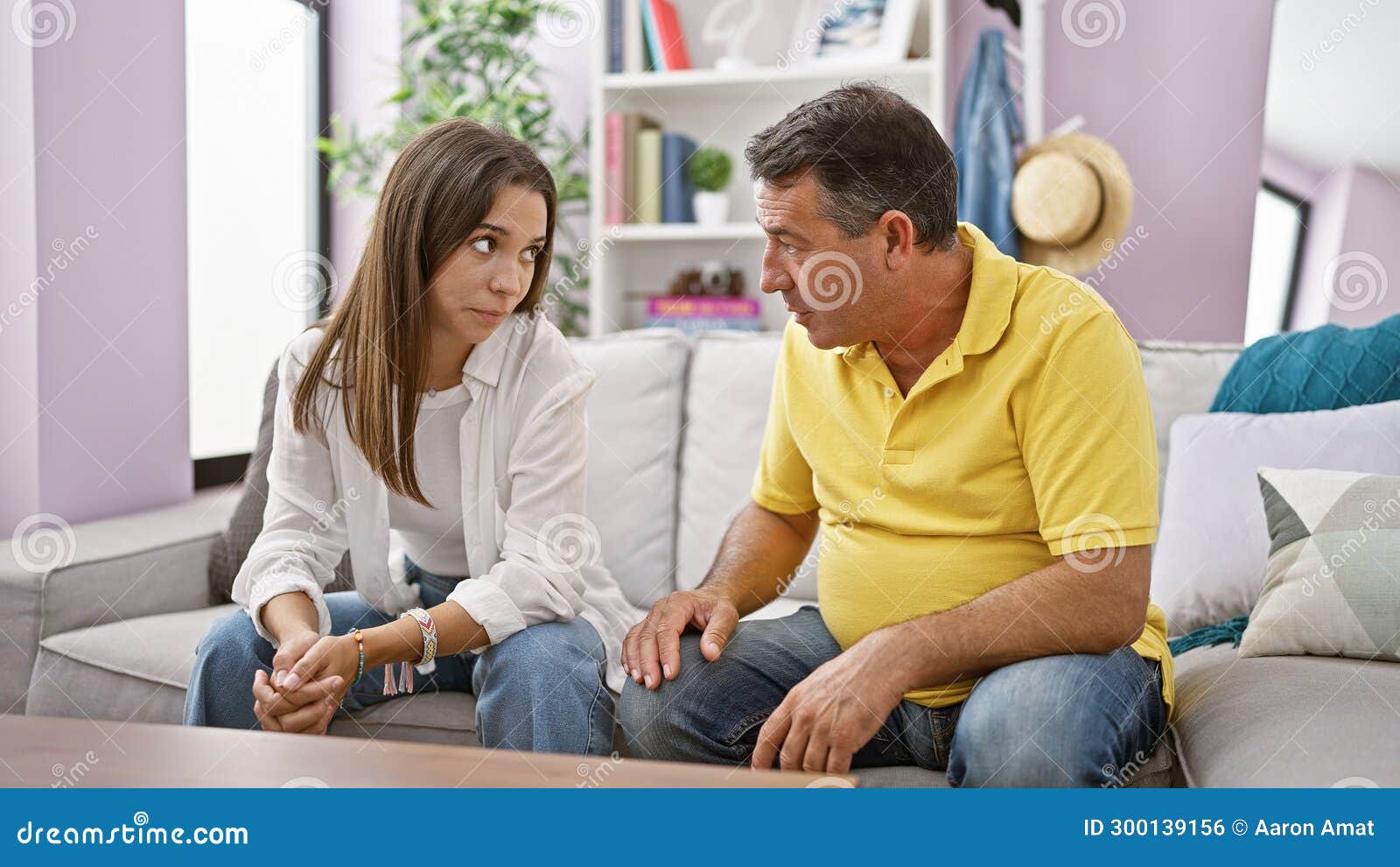 Father and Daughter Sitting on Sofa Together Speaking at Home Stock ...