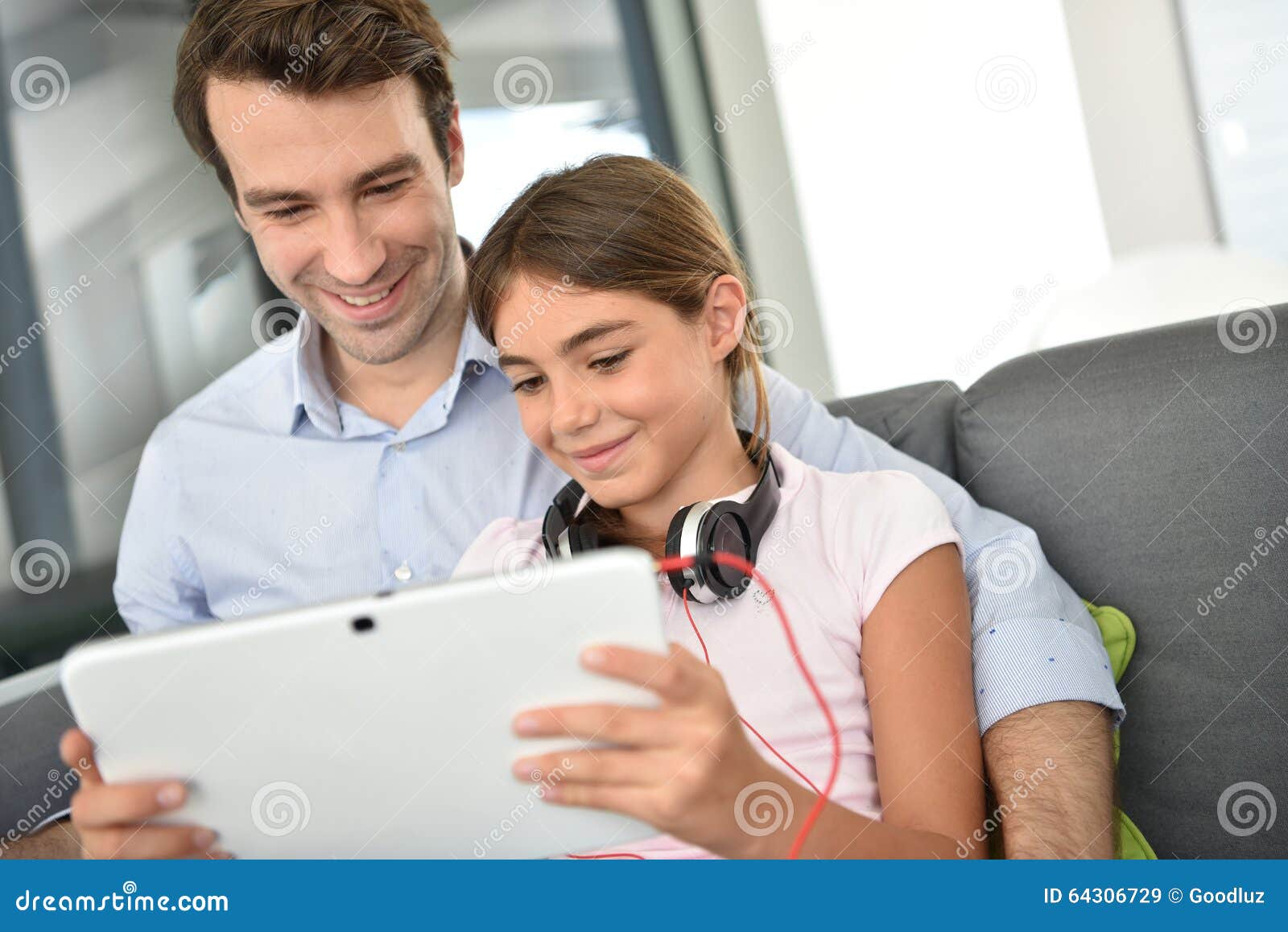 Father and Daughter Using Tablet at Home Stock Image - Image of ...