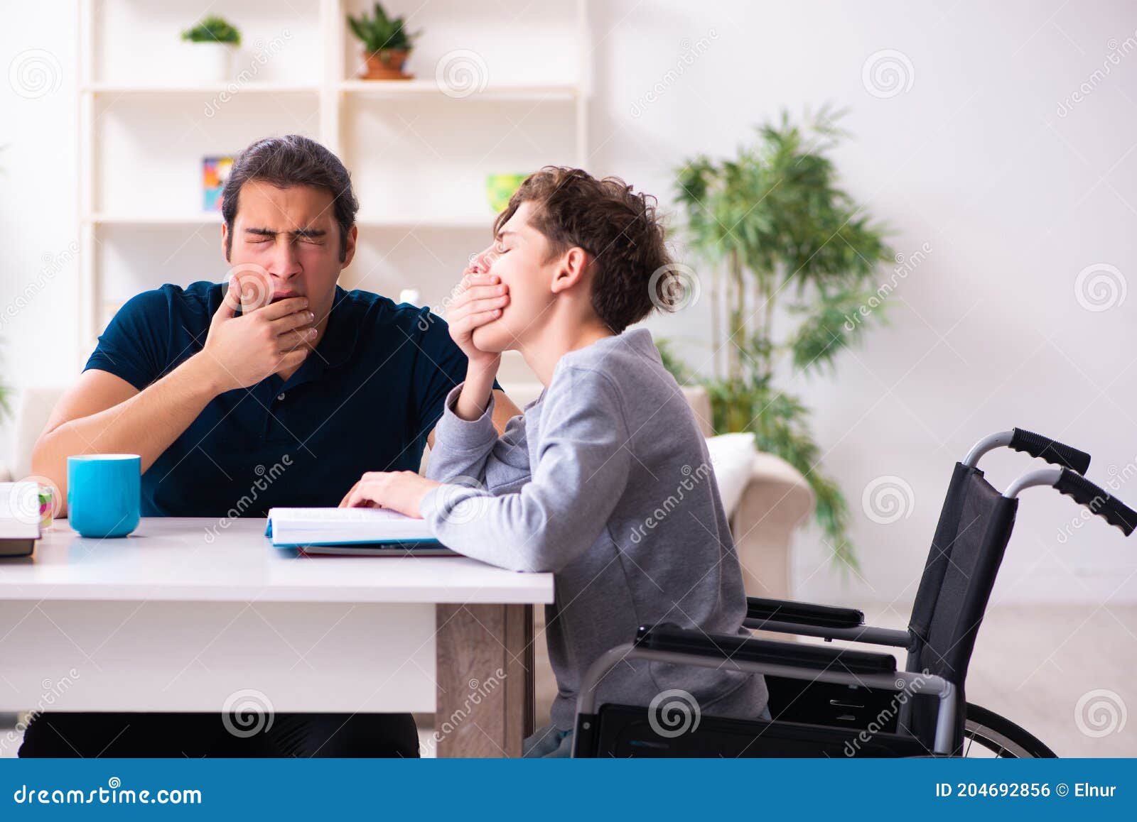 Father And Disabled Son In Wheelchair Visiting Grave At Cemetery Stock ...